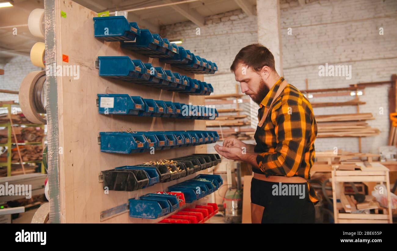Man worker choosing screws from hi-res stock photography and images - Alamy