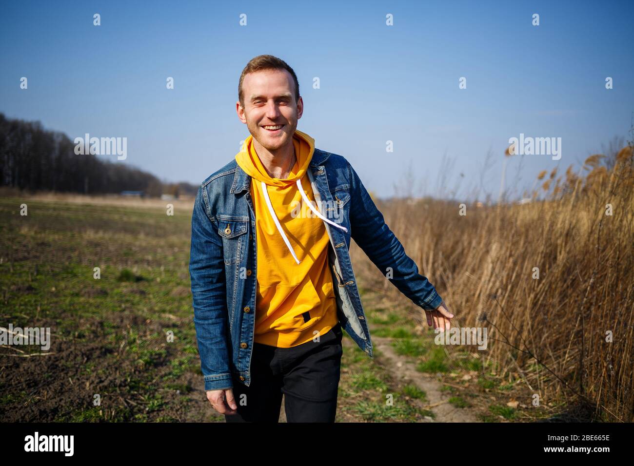 Smiling man enjoying wind blowing in forest. Happy man feeling joy ...