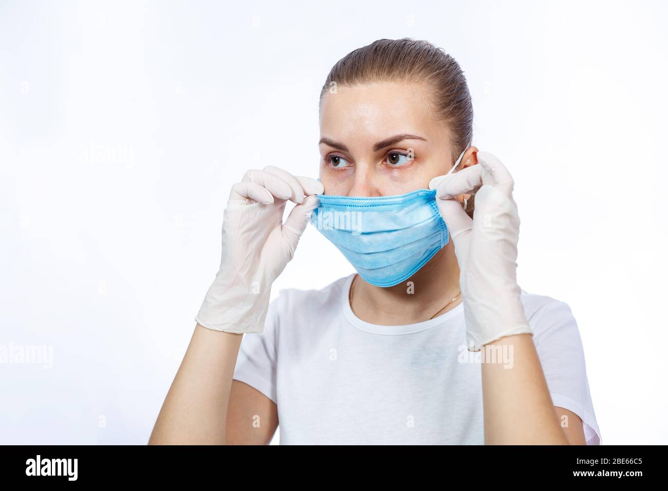 woman health worker demonstrates how to wear a protective medical ...