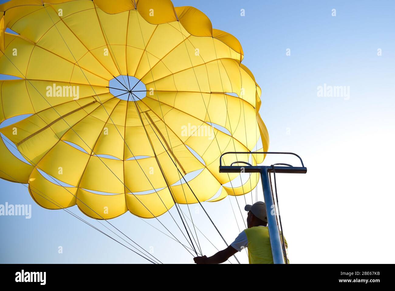 A man folds a parachute for paragliding on a boat Stock Photo - Alamy