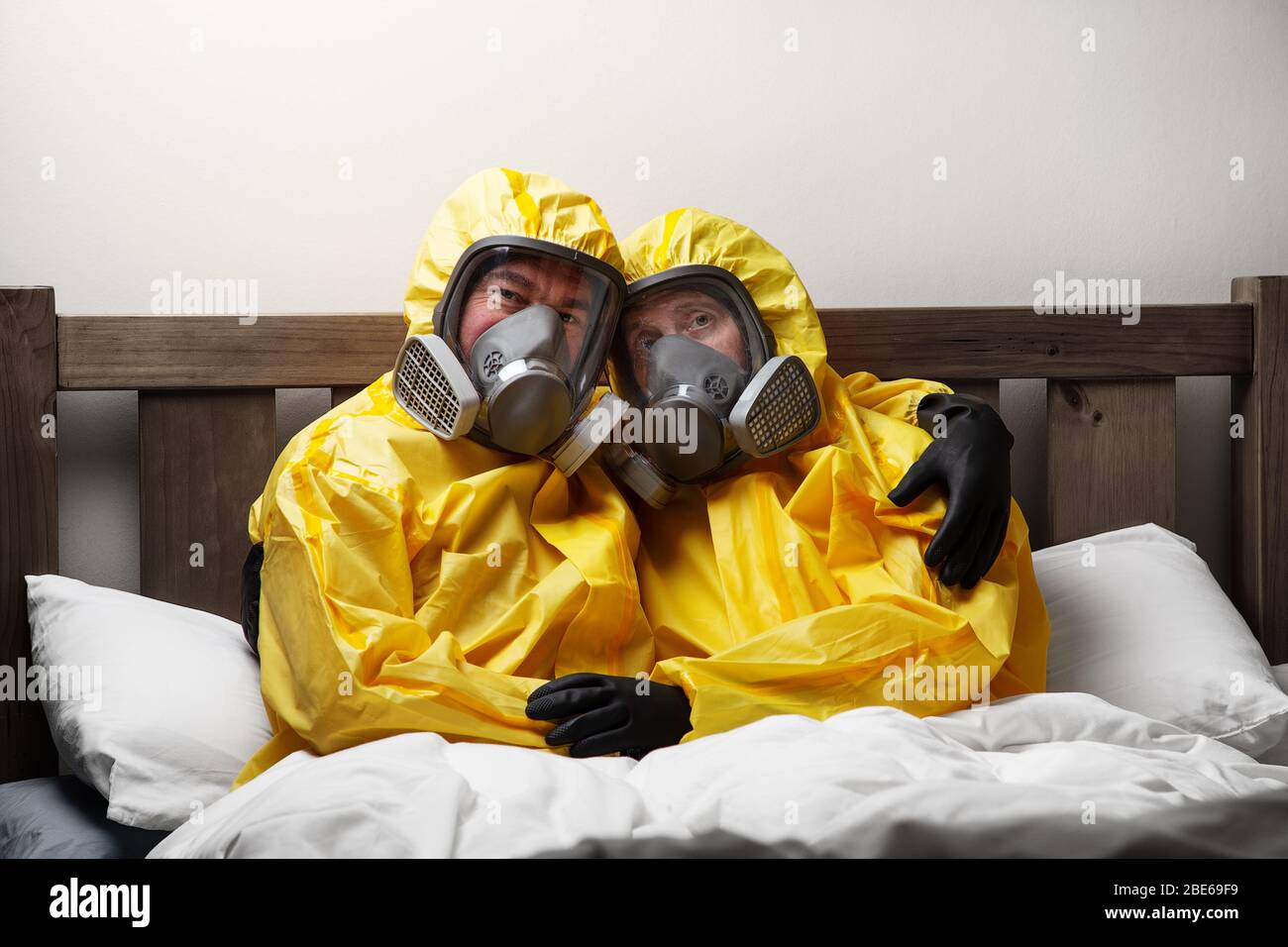 two people self isolating in bed being extra careful and wearing hazmat ...