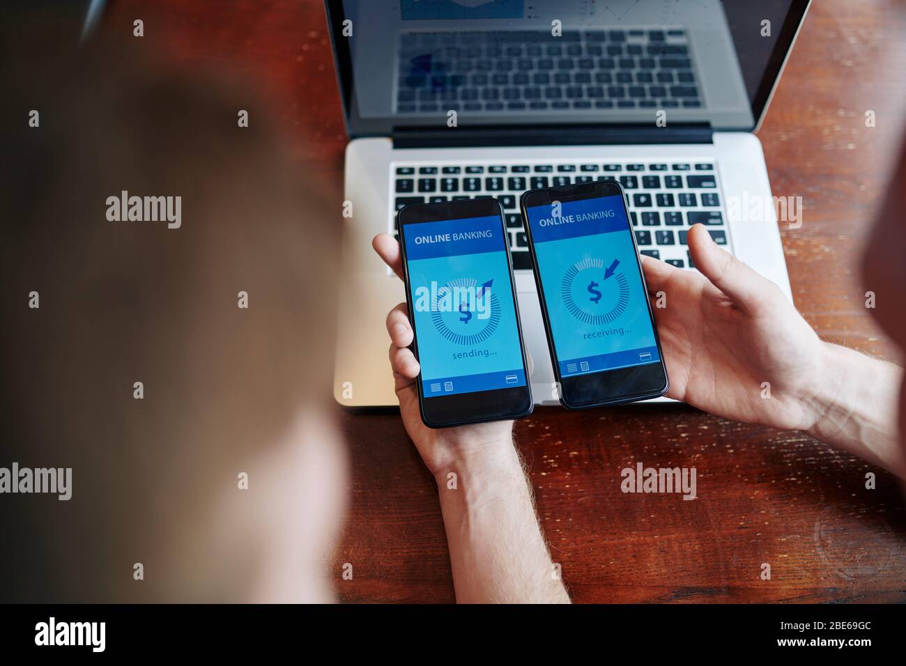 Young man transferring money to friend or colleague via mobile banking ...