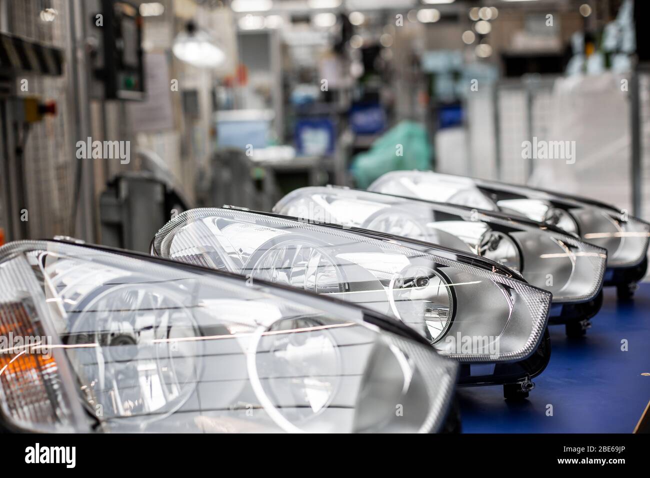 Close up of car headlamps, headlights in a row ready for assembly to ...