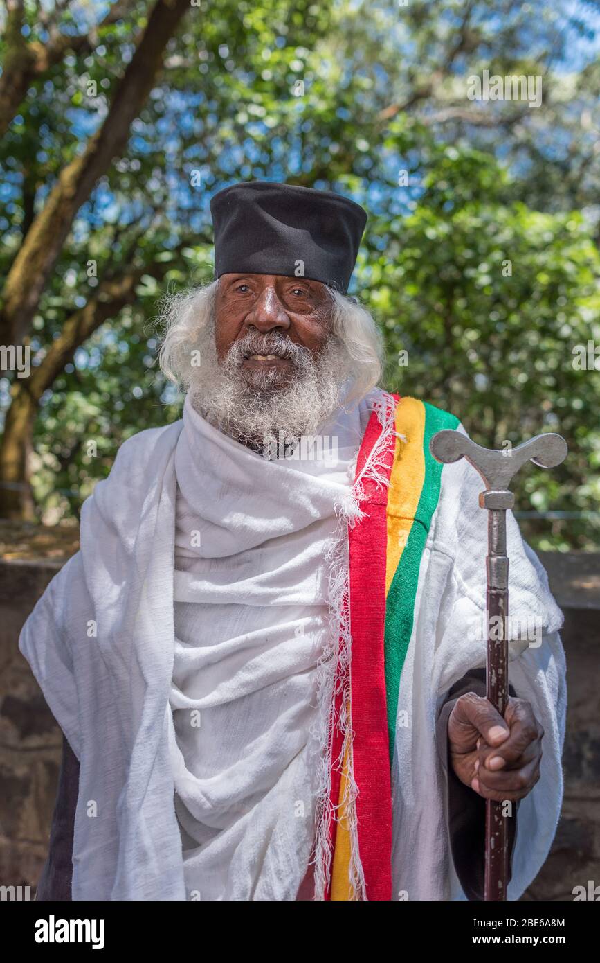 Aba Wolde Tensae in outdoor gardens holding staff, an Ethiopian ...
