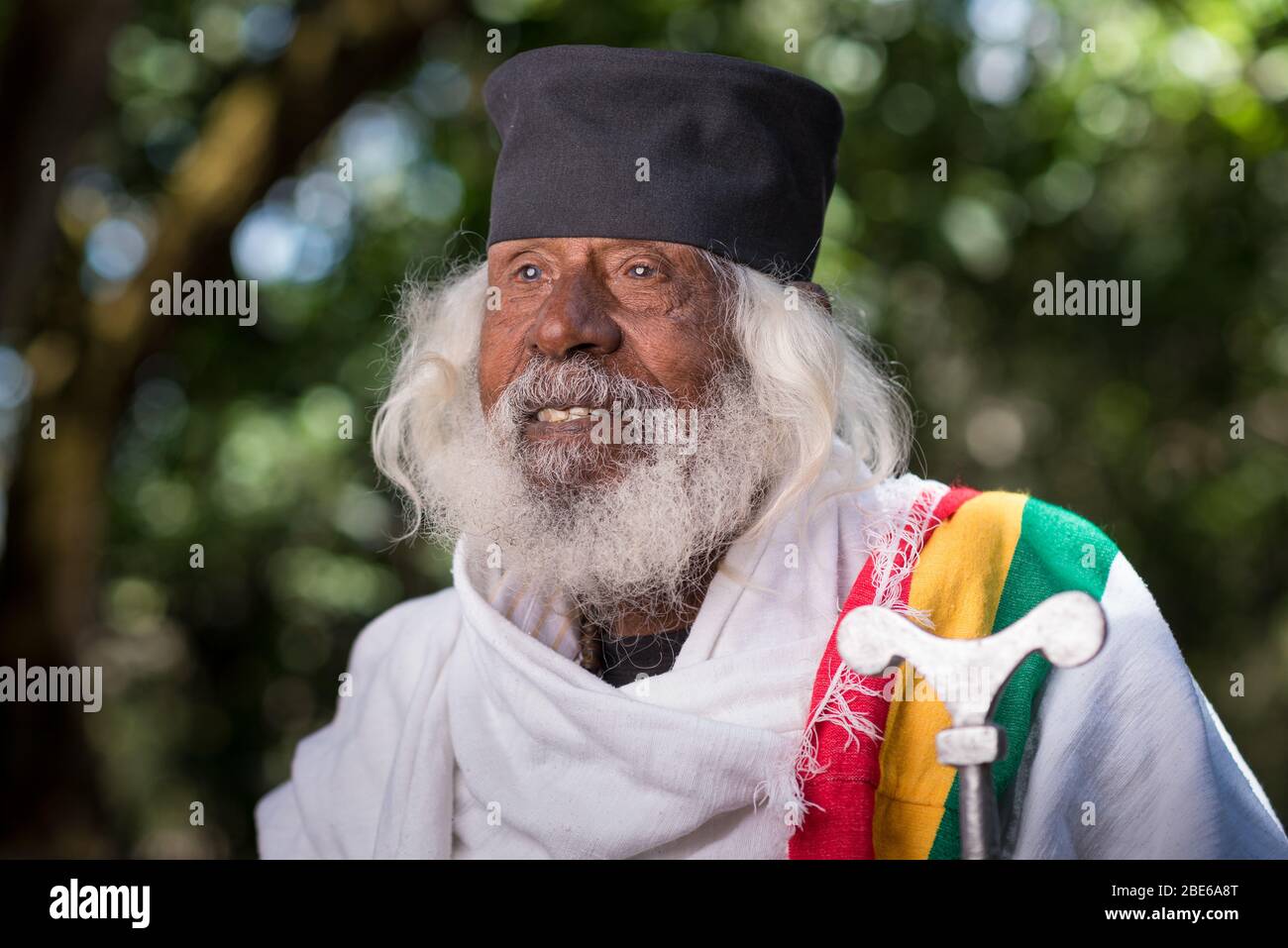 Aba Wolde Tensae in outdoor gardens holding staff, an Ethiopian ...