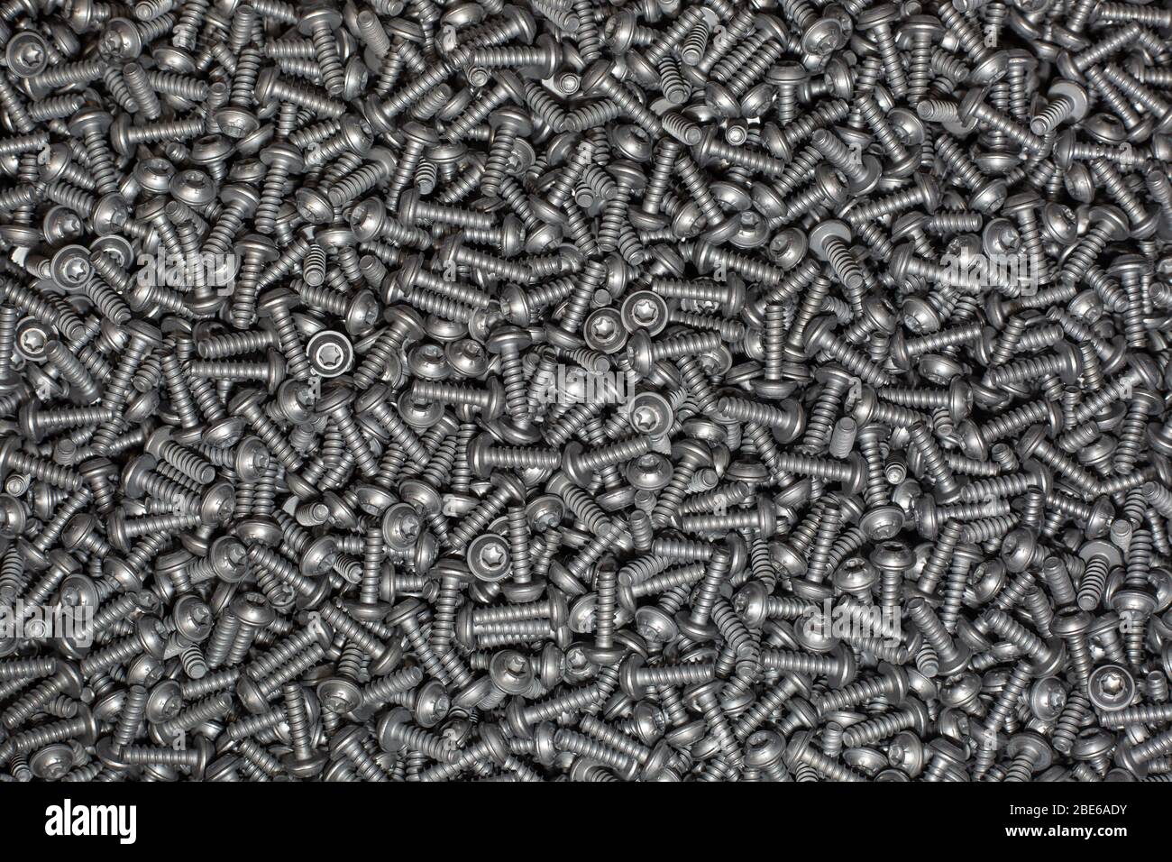 A lot of tapping metal or iron screws, screws as a background ...
