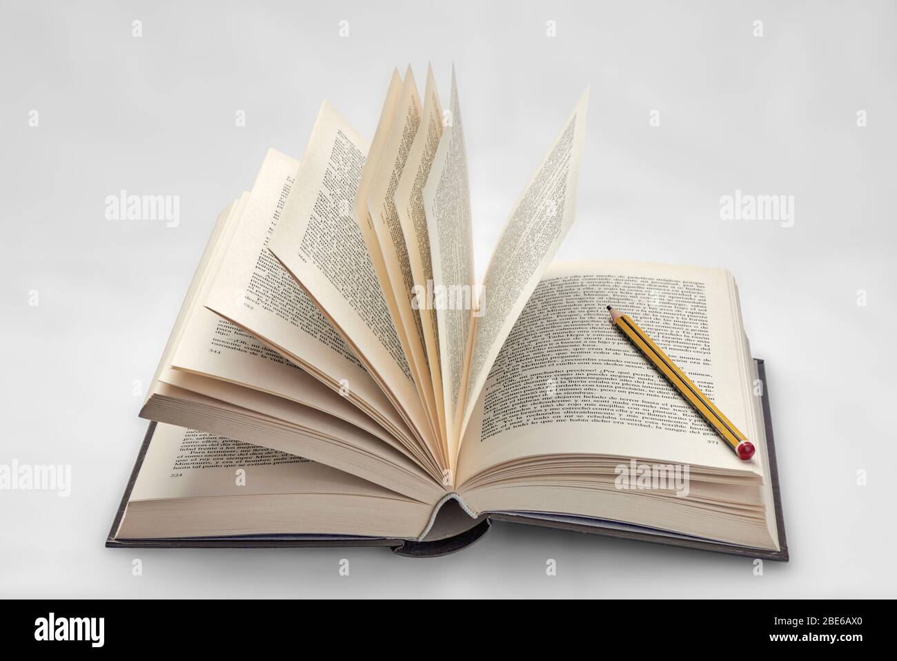 Still life of an open book with a pen on top. Research, Development and ...