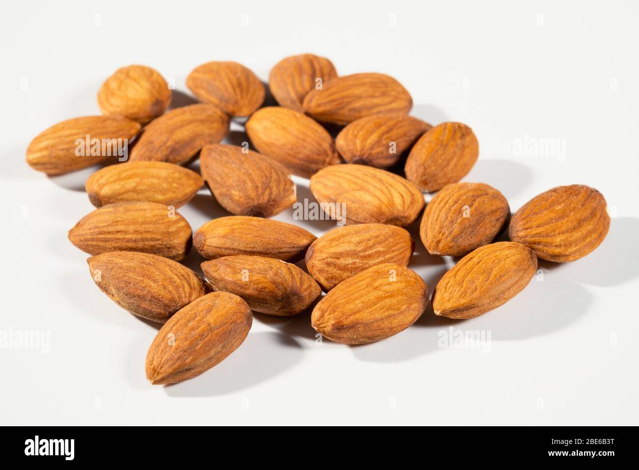 Close up shot of Almonds on a white background Stock Photo - Alamy