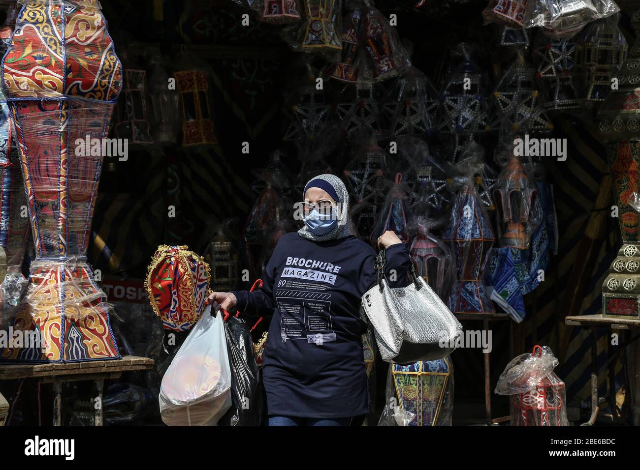 Cairo, Egypt. 12th Apr, 2020. A woman wearing a face mask walks at the ...