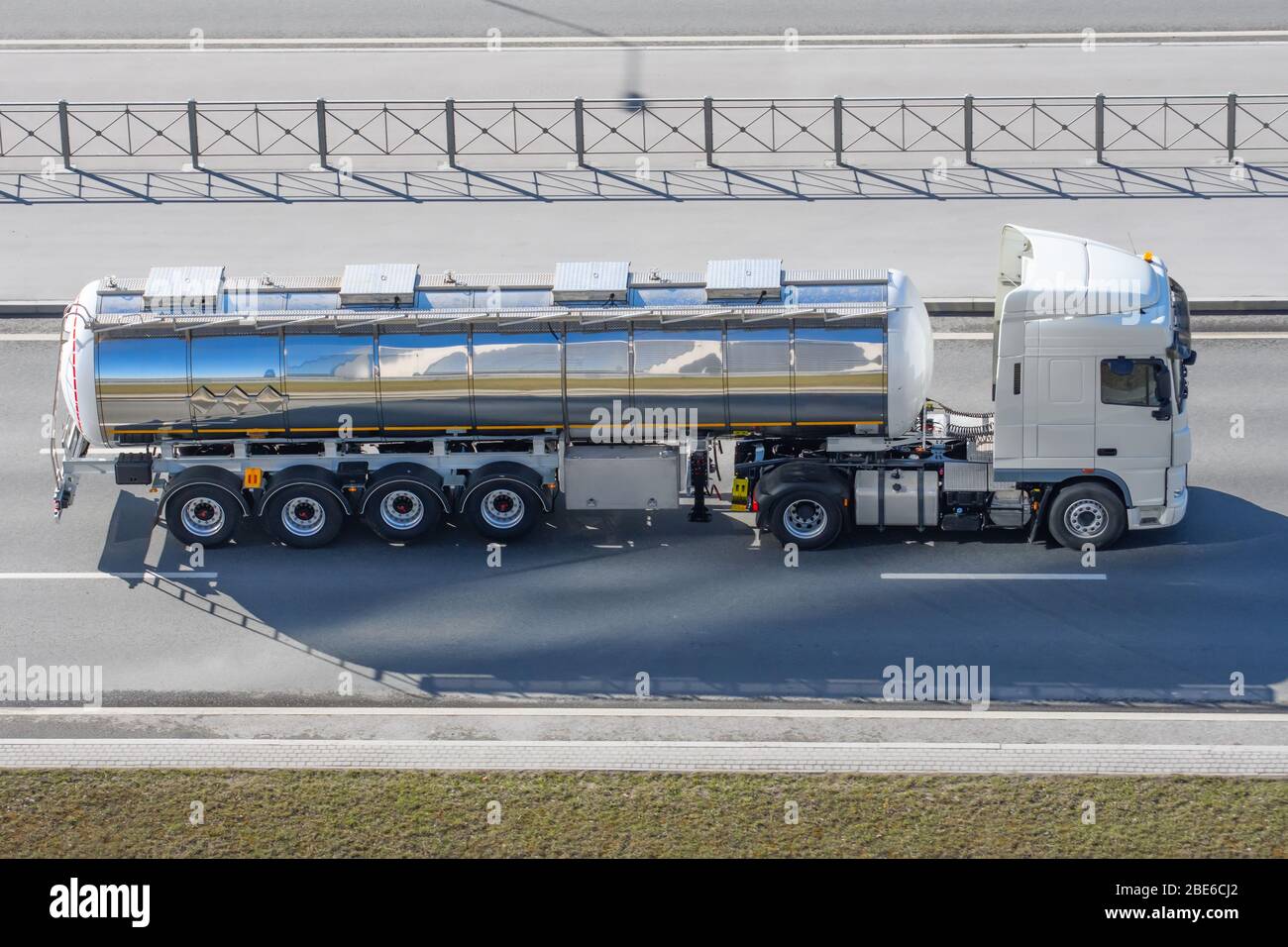 Heavy big fuel tanker with shiny metal lame tank driving on city ...