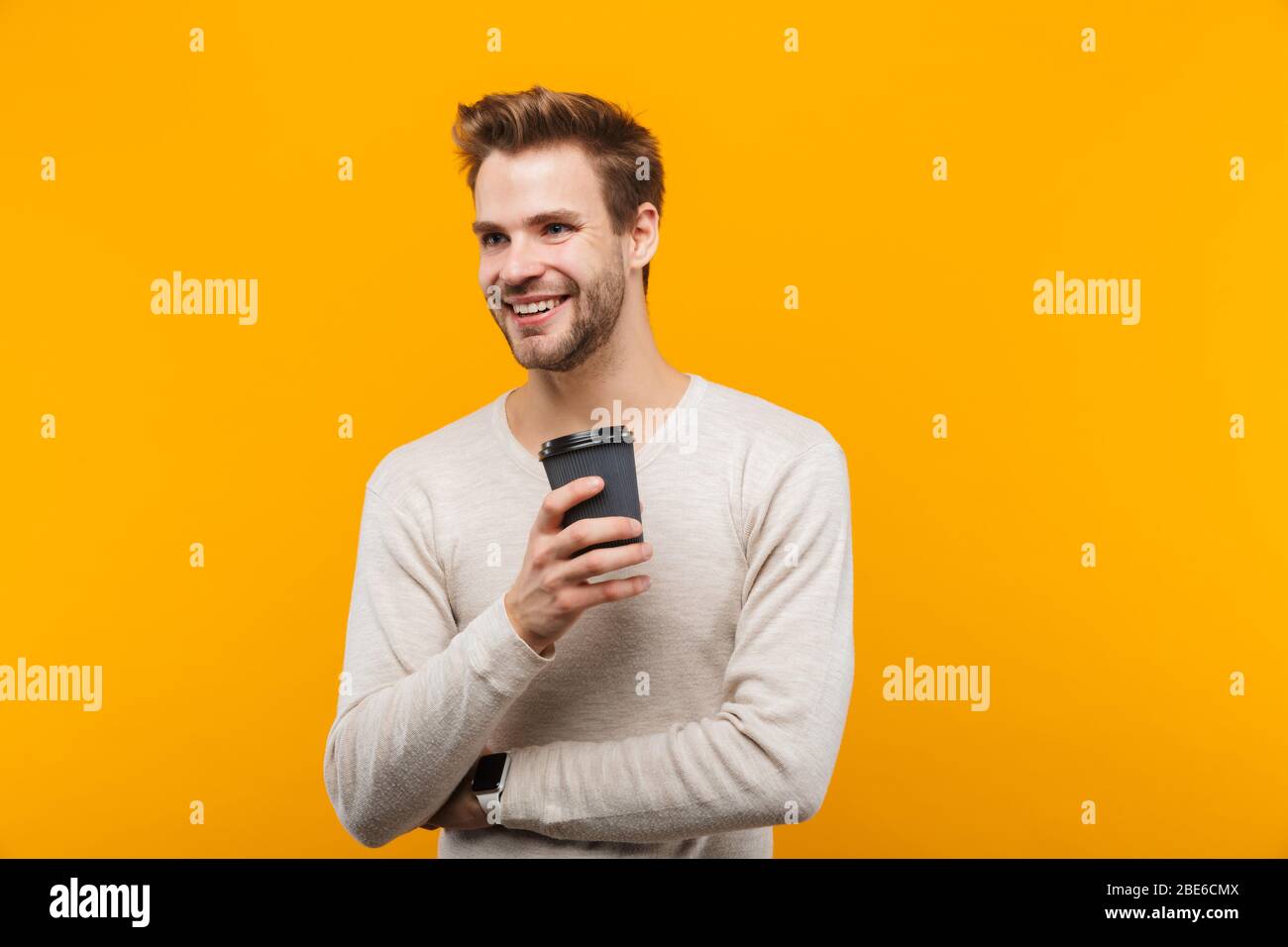 Attractive happy young man wearing pullower standing isolated over ...