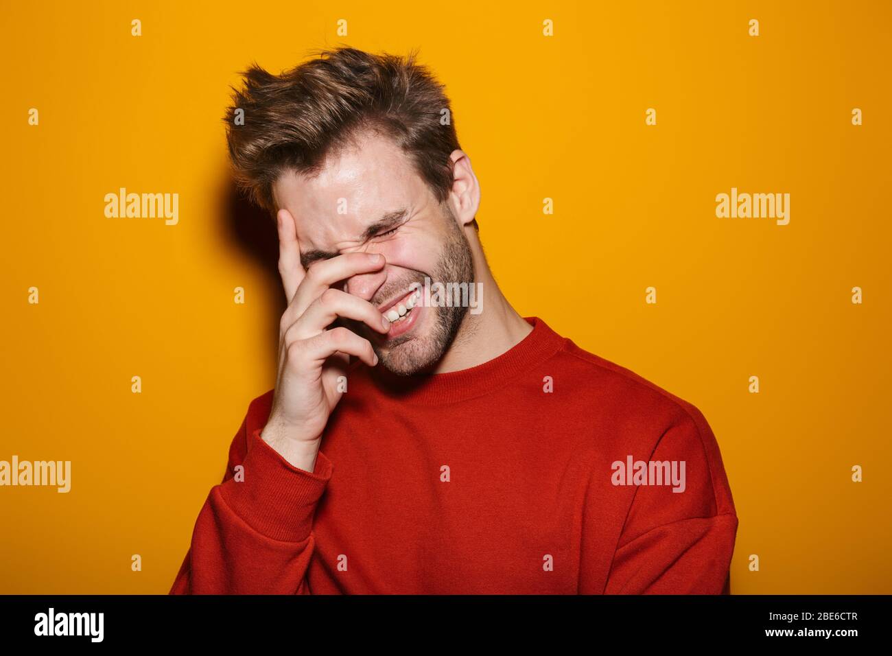 Attractive happy young man wearing pullower standing isolated over ...