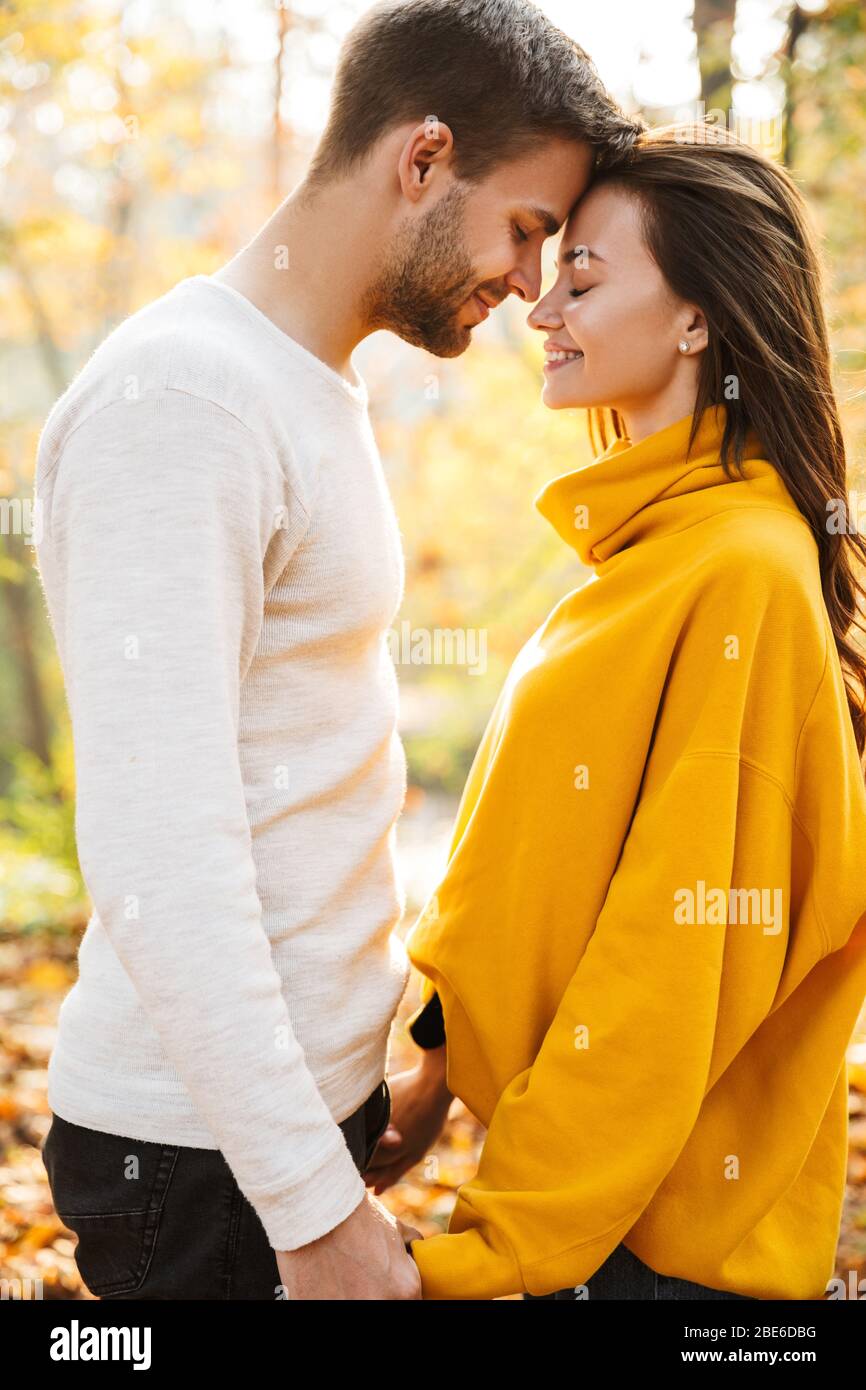 Image of attractive young caucasian couple in love hugging while ...