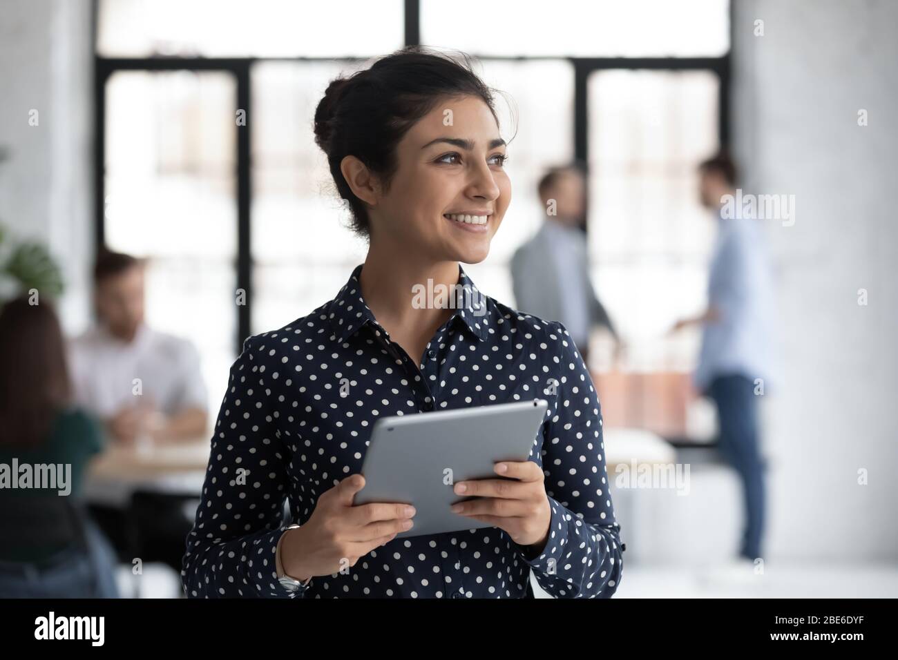 Young indian female employee look in distance planning Stock Photo - Alamy