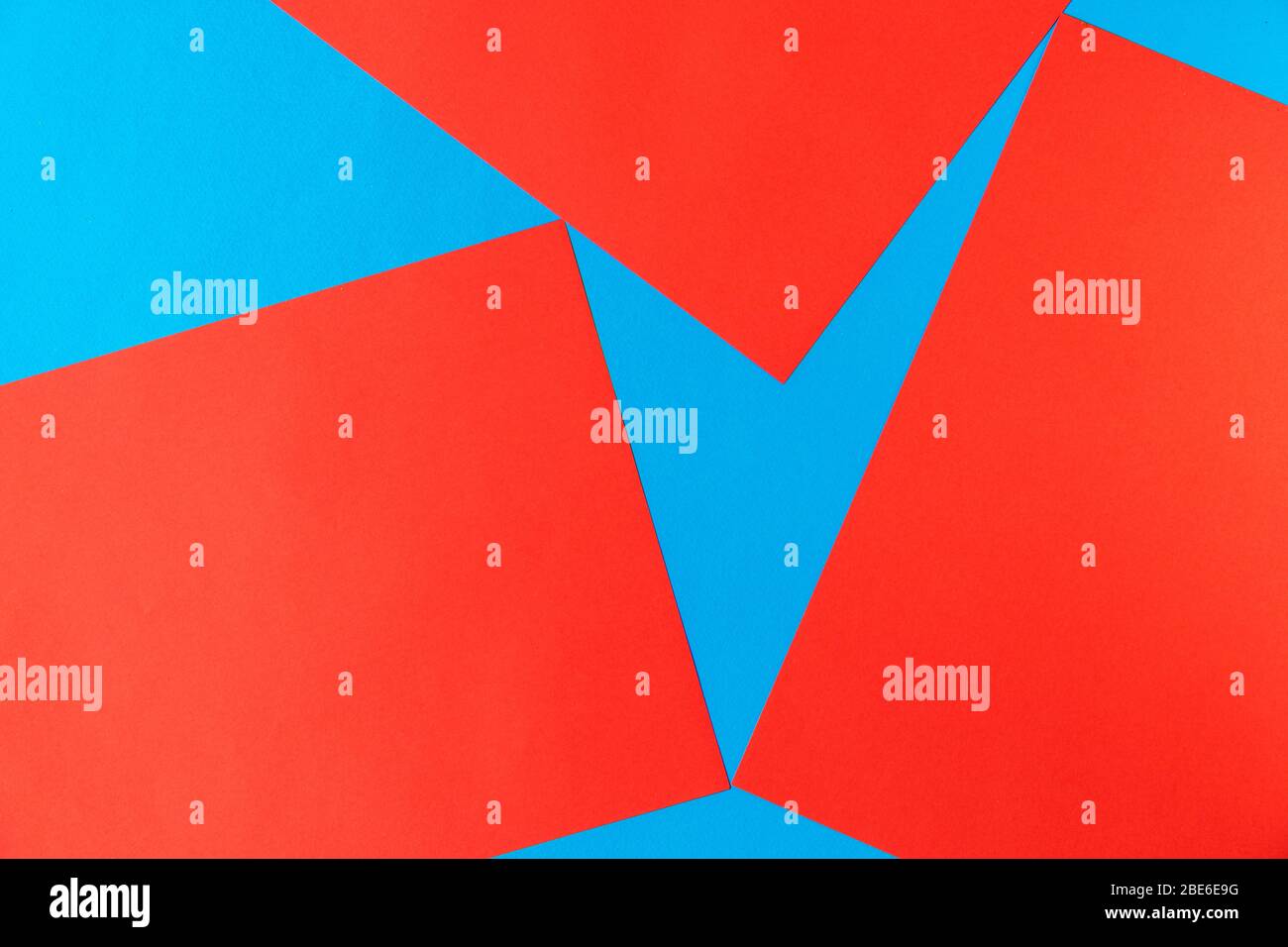 A pattern of bright red and blue pieces of paper, with clear angles and ...