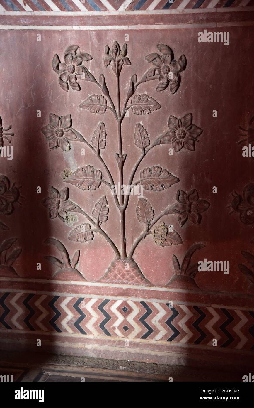 Dawn light illuminates a sandstone floral spray relief inside the Taj ...