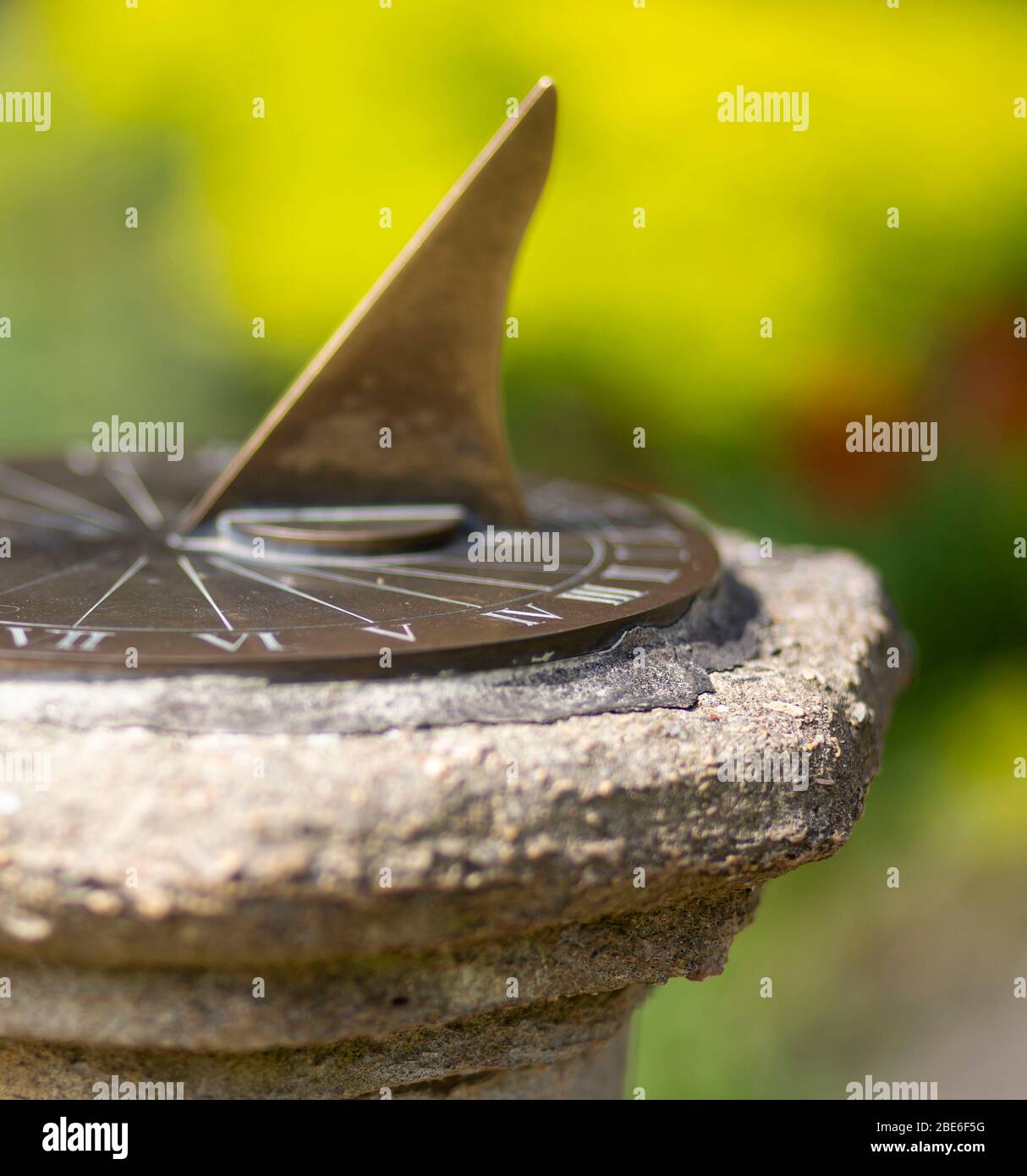 Close up of sundial on a stone plinth Stock Photo - Alamy