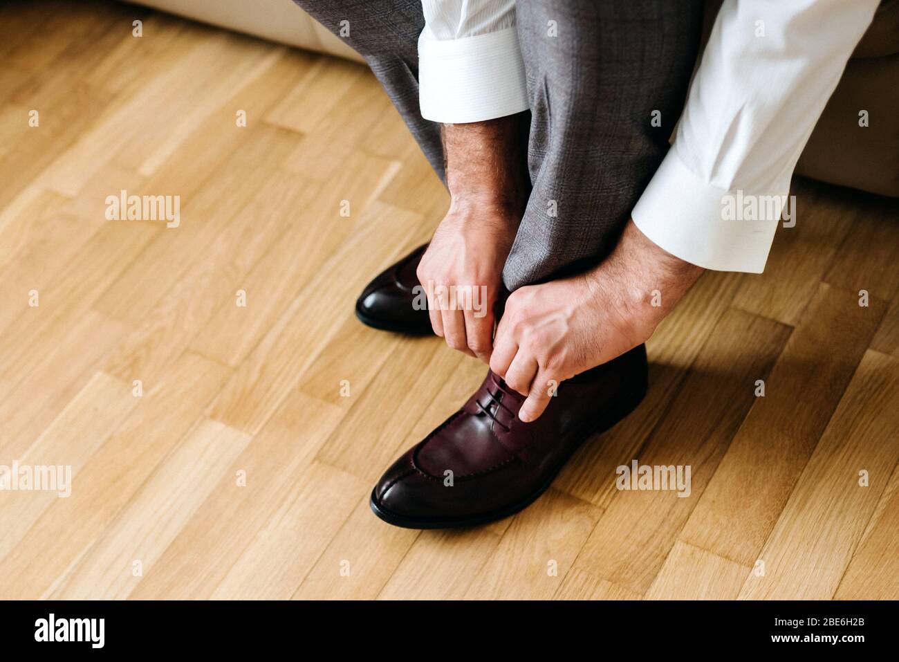 businessman putting on shoes, man getting ready for work, groom morning ...