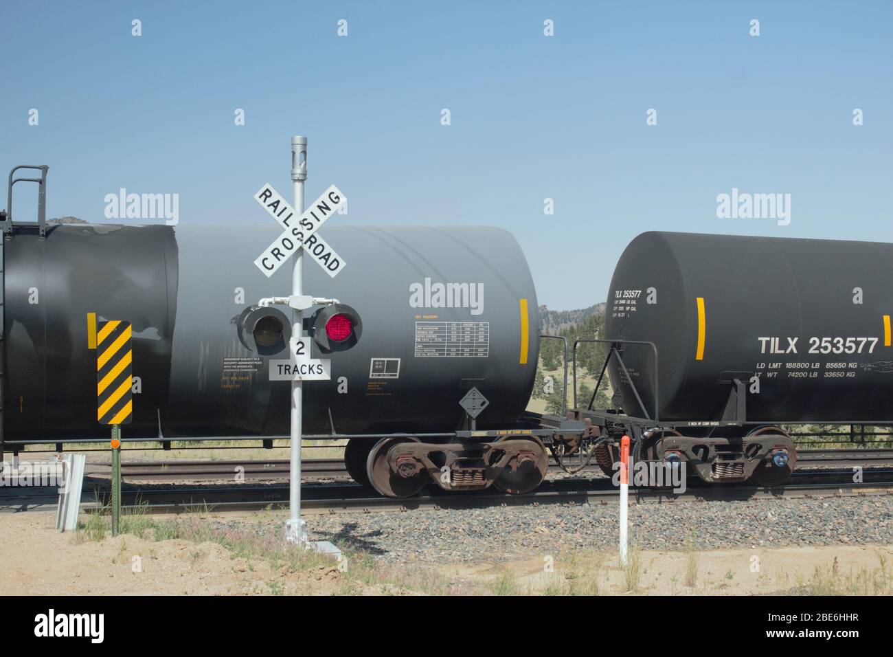 Railroad Crossing with tank train Stock Photo - Alamy