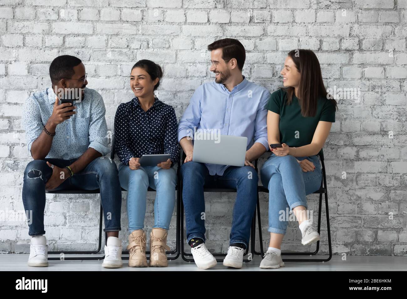 Happy multiracial candidates have fun waiting for interview Stock Photo ...