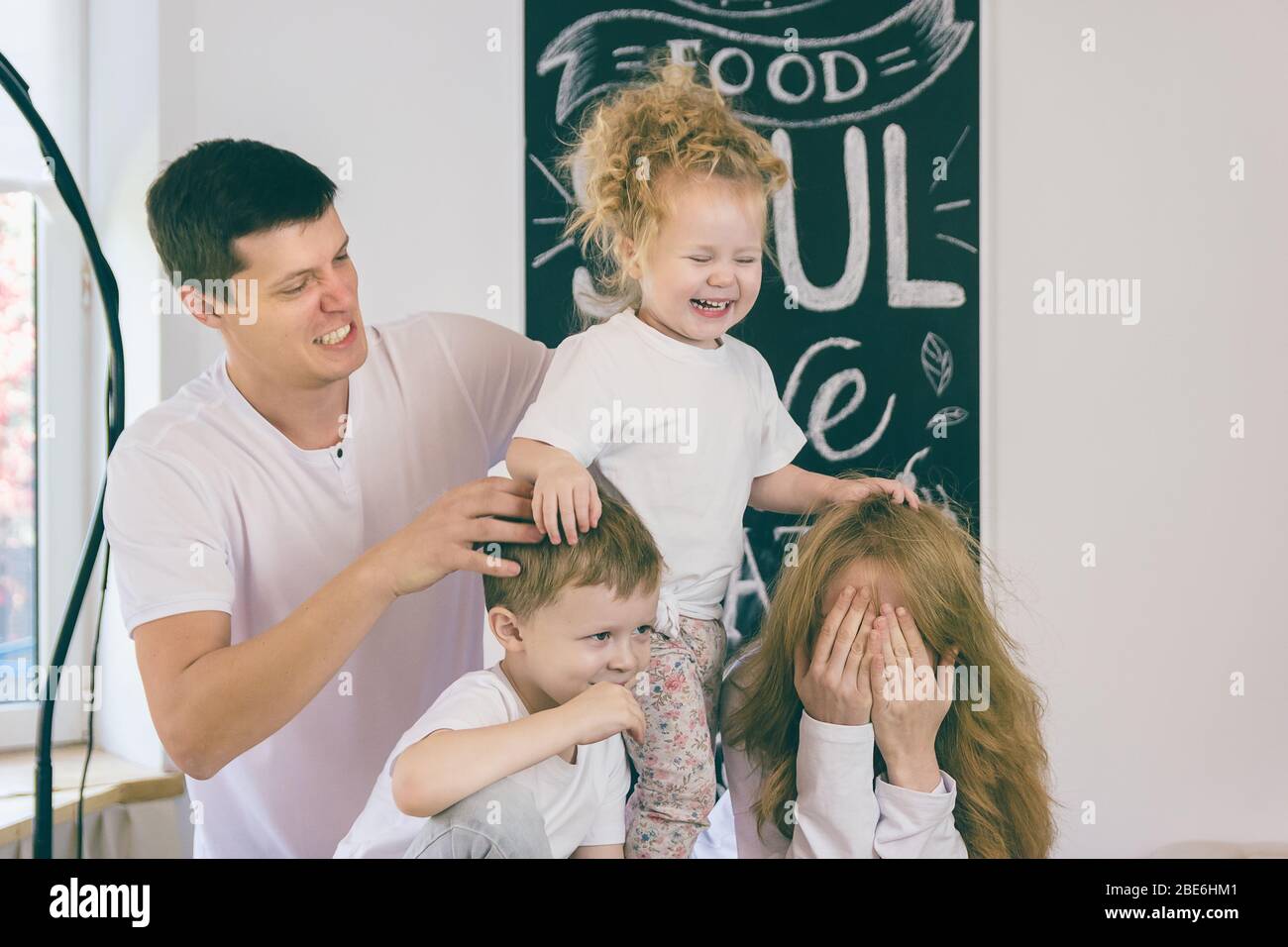 Father spends his spare time with his family. Kids play with their ...