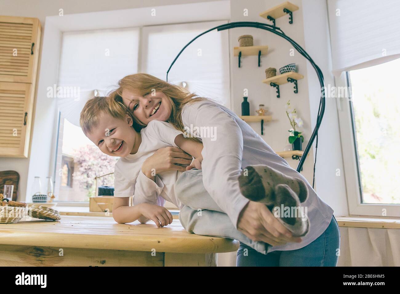 Happy mom and son are laughing resting at home Stock Photo - Alamy