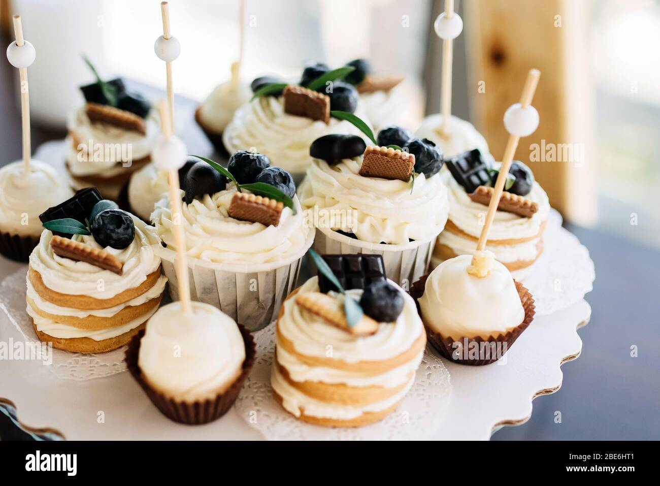 Group of many small tasty little sweet snacks, tiny cakes. Lots of mini ...