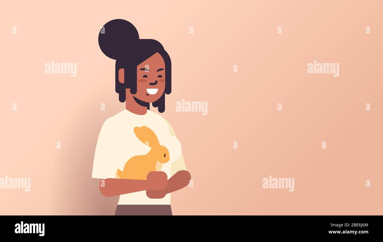 african american woman holding rabbit smiling girl with cute bunny ...