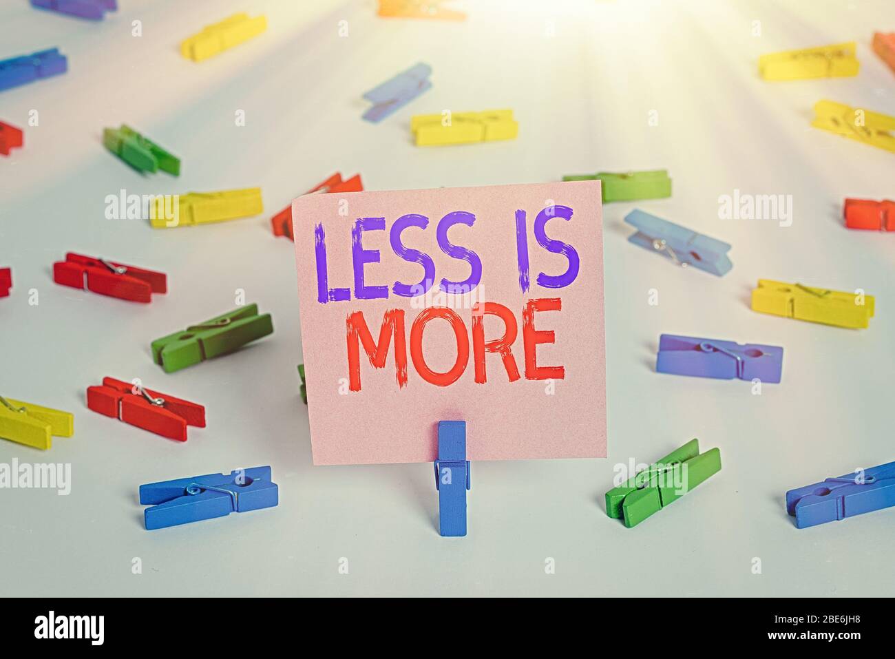 Writing note showing Less Is More. Business concept for used to express ...