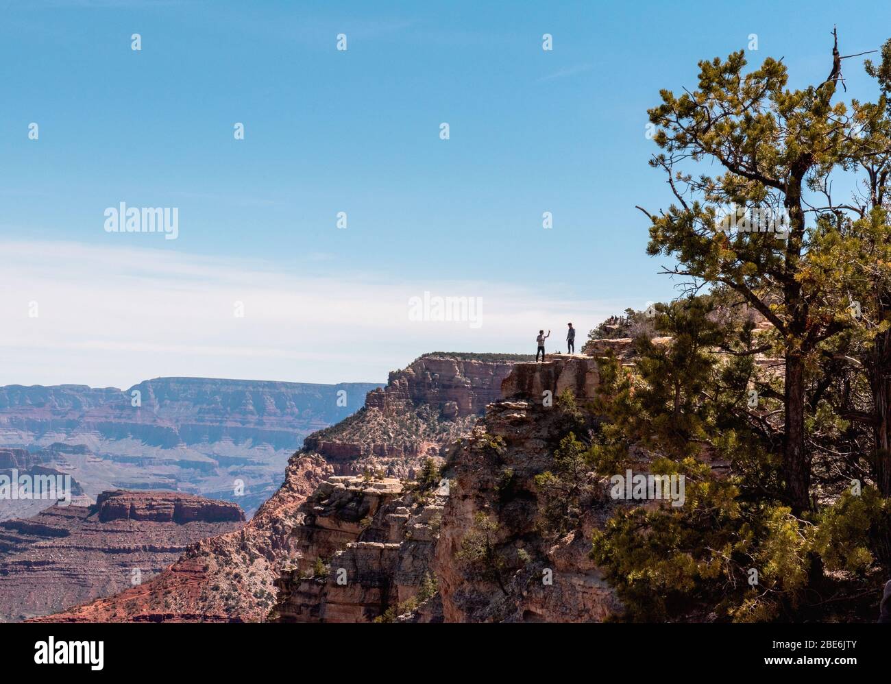 Standing on the edge of a cliff in the South Rim of the Grand Canyon ...