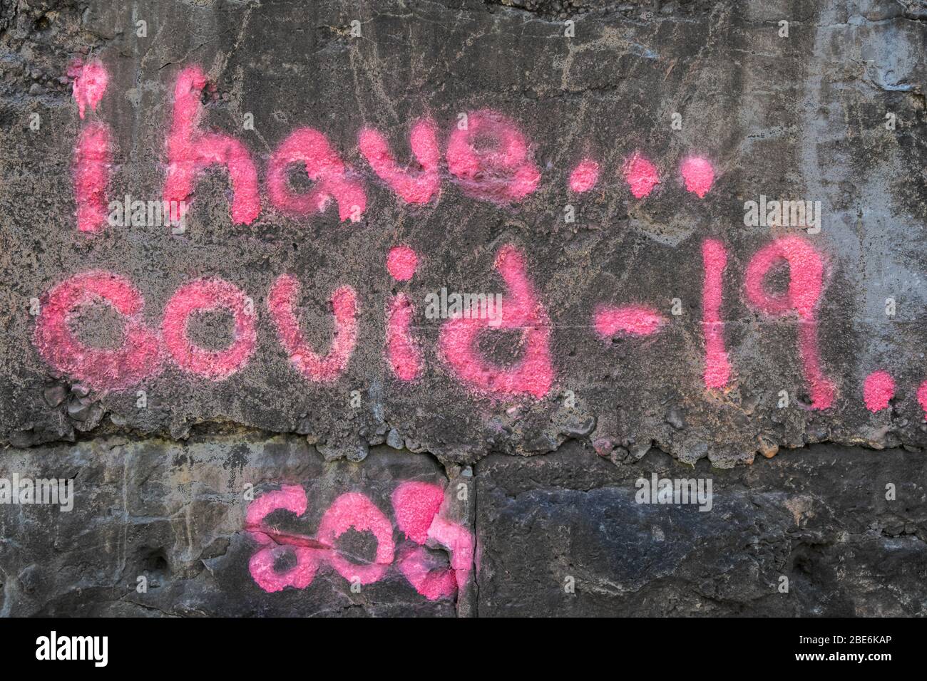 "I have...covid-19.. sos" graffiti on the stone wall Stock Photo - Alamy