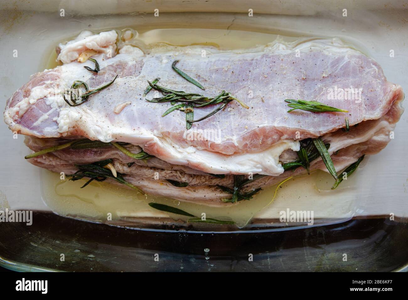 Raw fat pork meat seasoned with salt, papper, garlic and rosemary ...