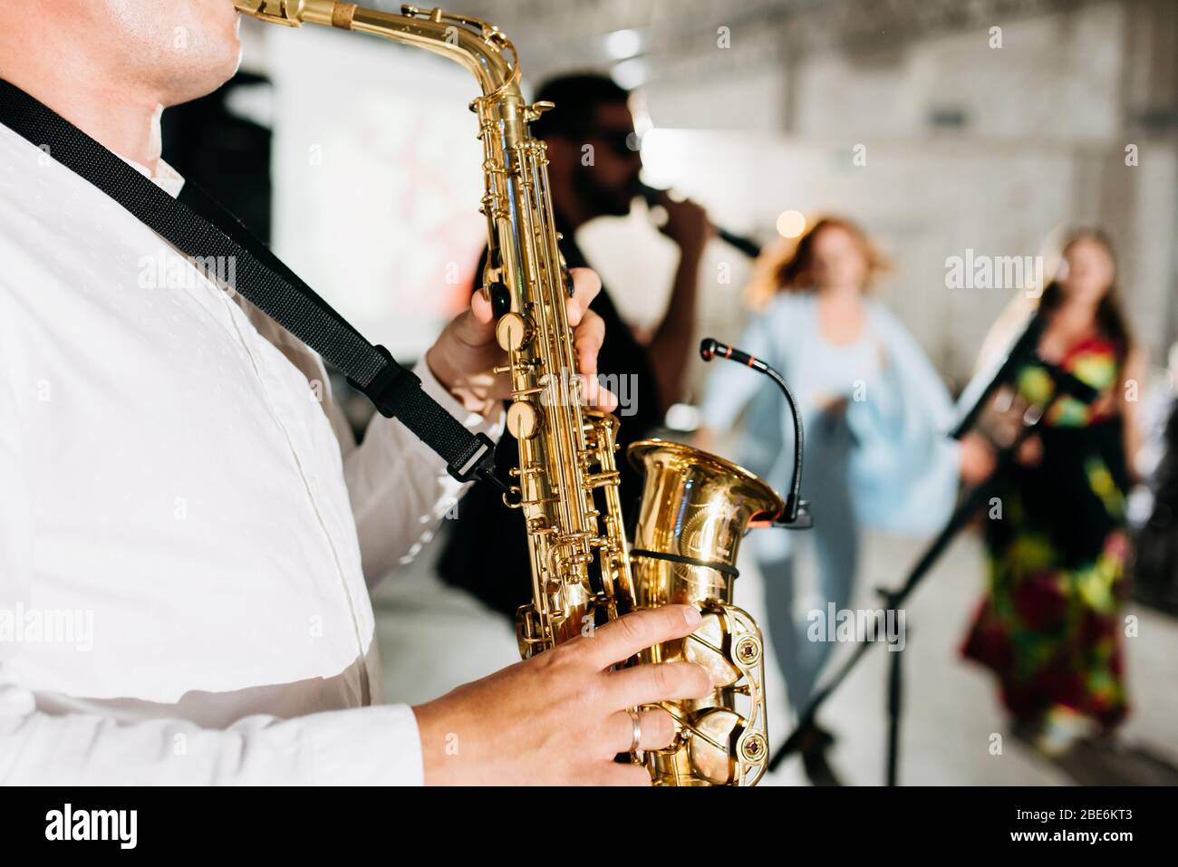 Concert view of a saxophone player with vocalist and musical jazz band ...