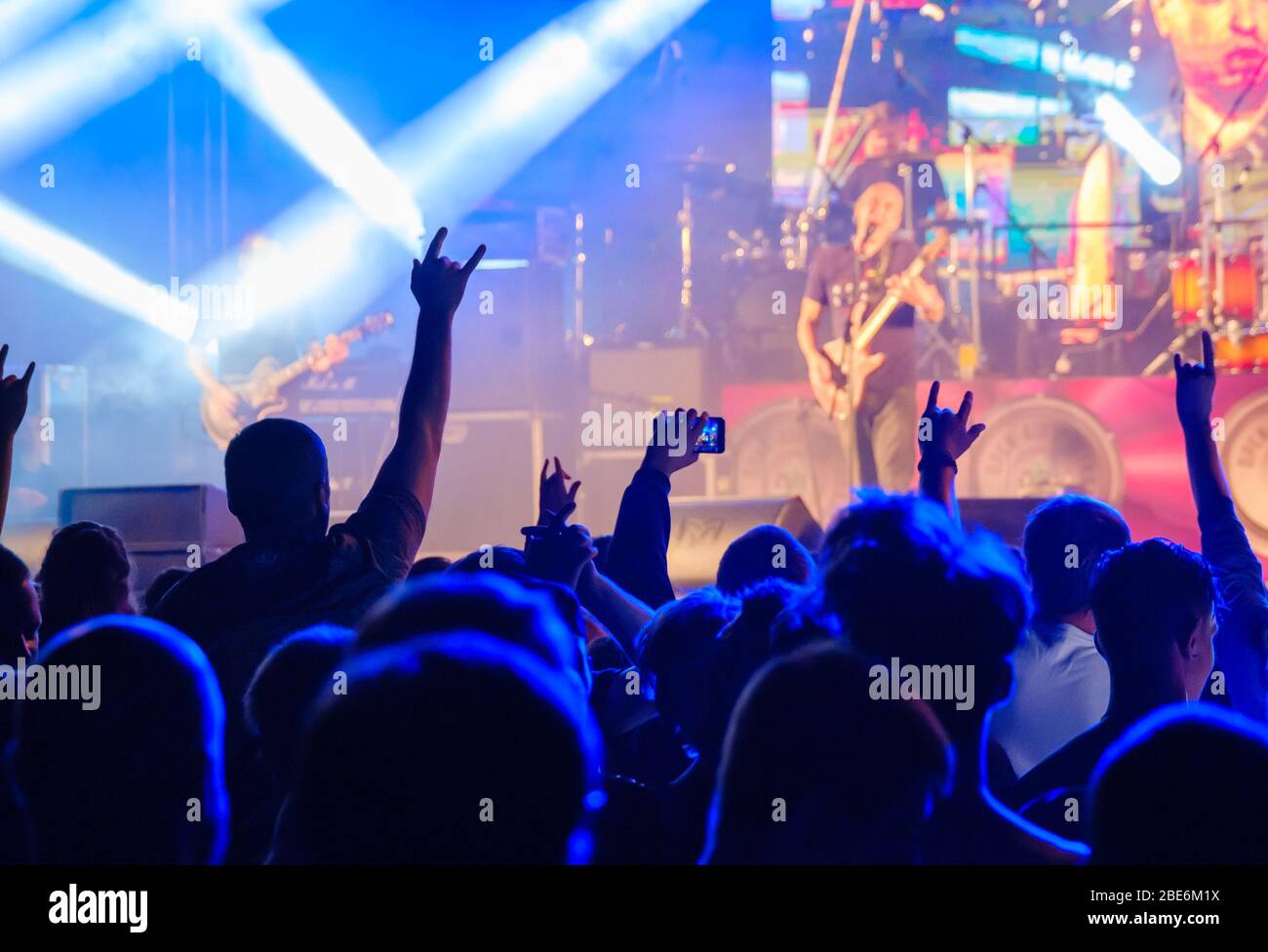 Fans listening to rock band on stage Stock Photo - Alamy