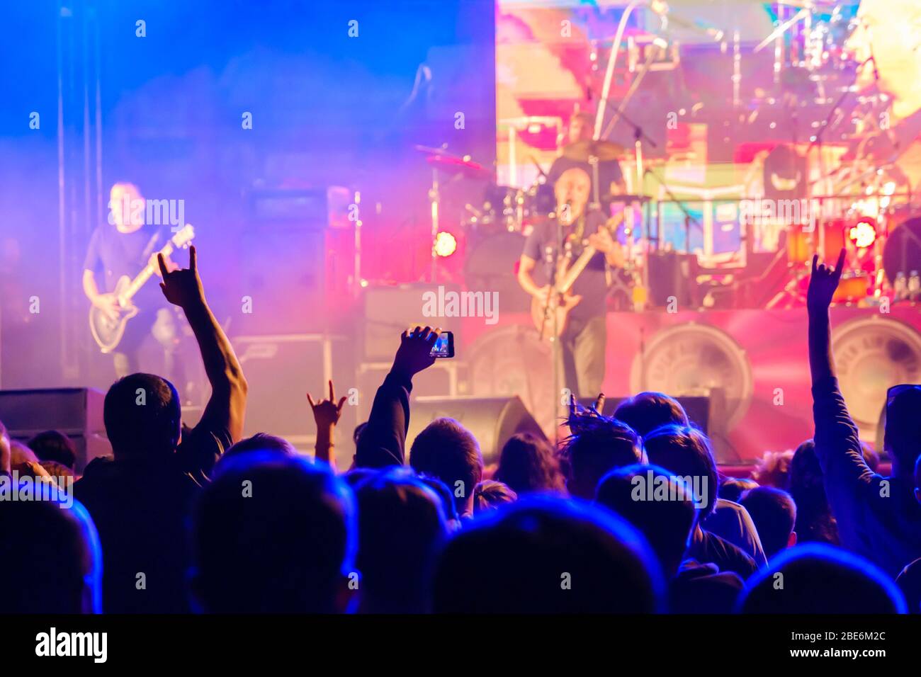 Fans listening to rock band on stage Stock Photo - Alamy
