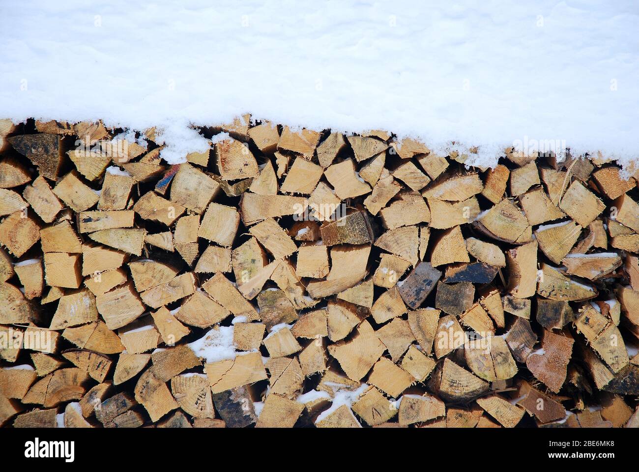 Stack of fire wood in covered with snow Stock Photo - Alamy