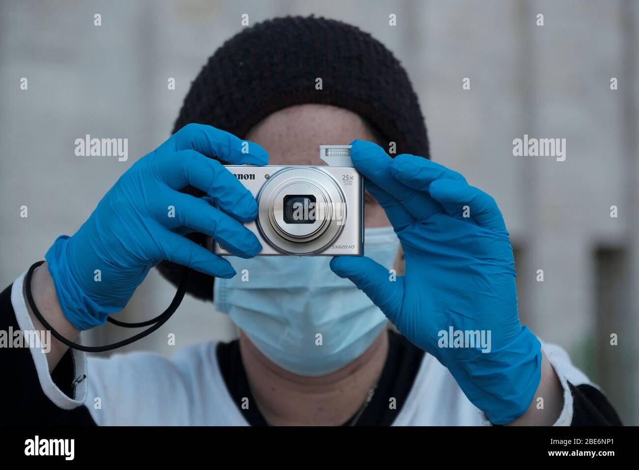 An ultra orthodox Jewish woman wearing protective mask and latex gloves ...