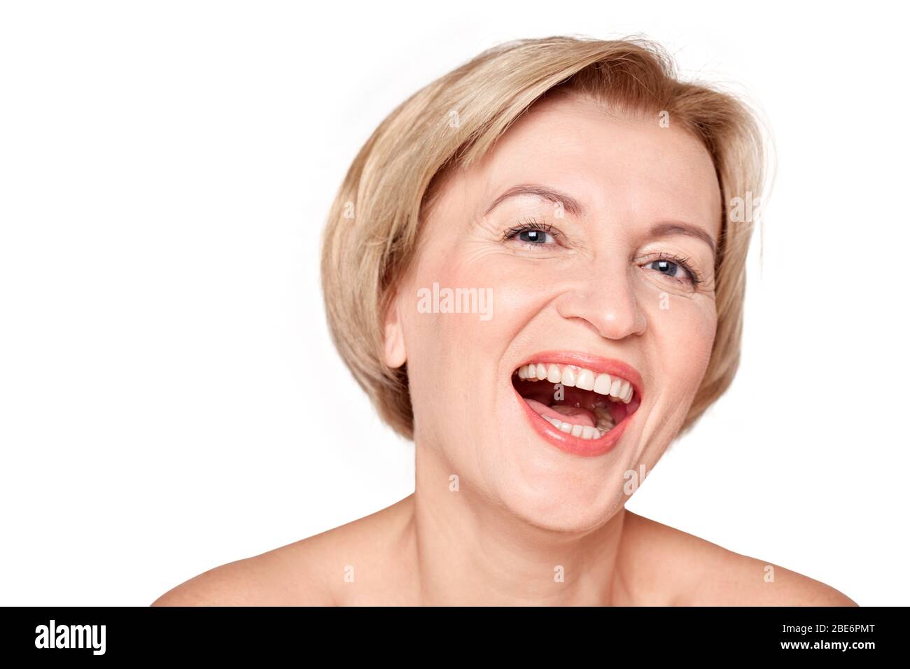 Mature aged female laughing and making happy face Stock Photo - Alamy