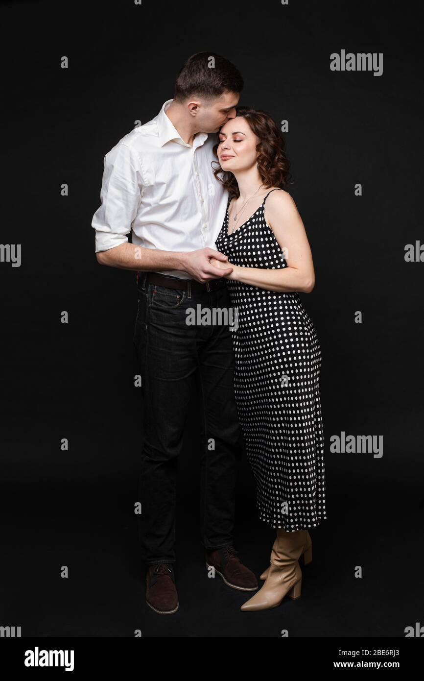Loving couple snuggling on black background. Love concept Stock Photo ...