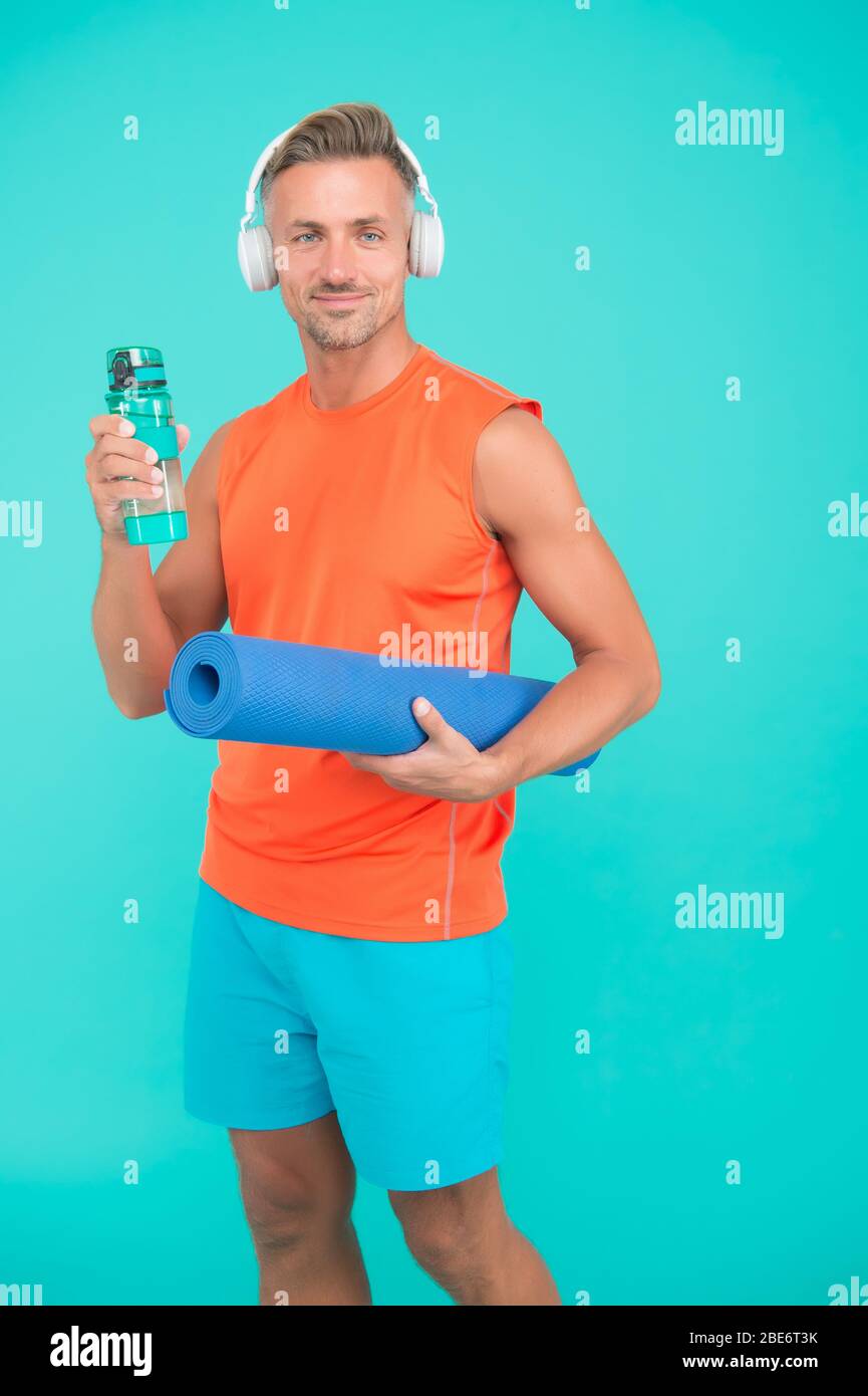 Challenge multiple muscle groups. Man practicing yoga at home. Mature ...