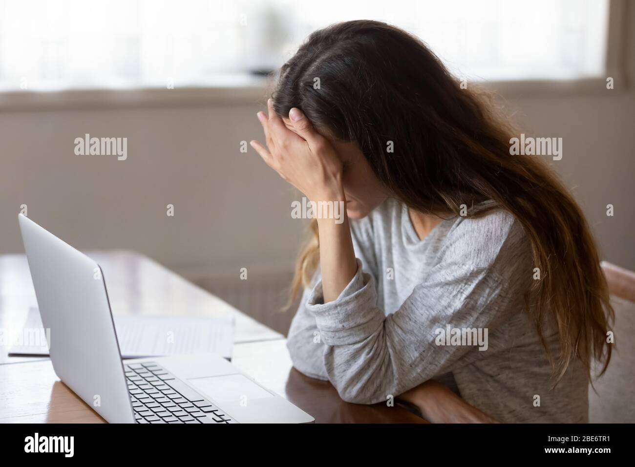 Tired girl having painful feelings due to computer overuse Stock Photo ...