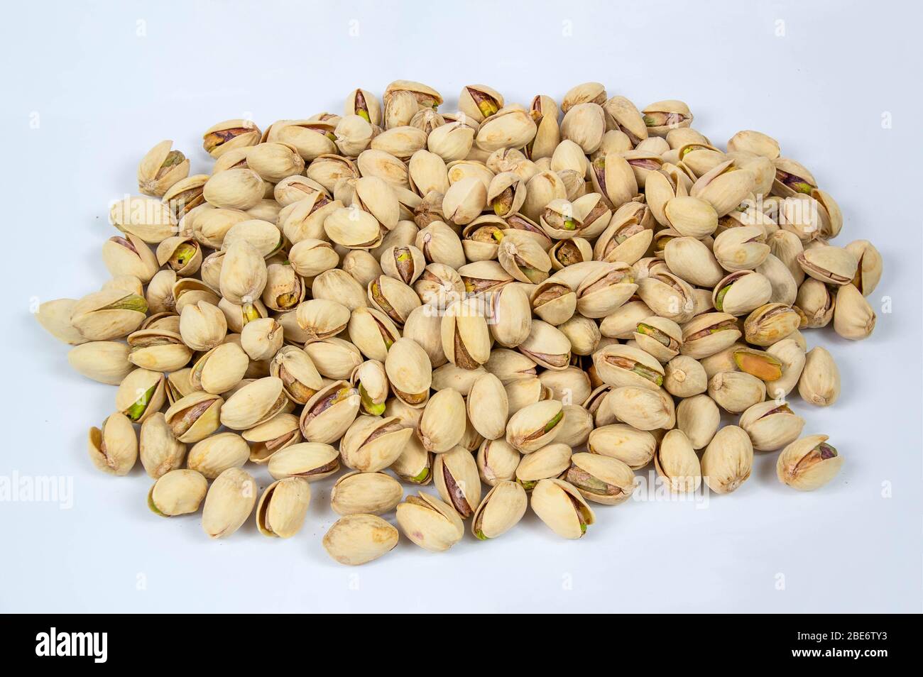 Salted and roasted pistachio nuts on a white background Stock Photo - Alamy
