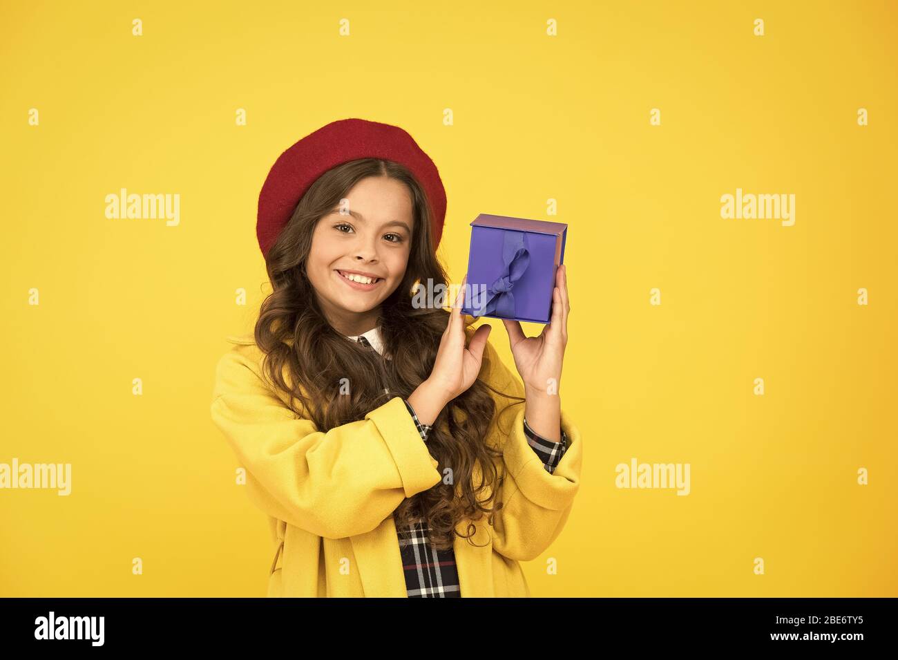 Surprise and pleasant present box. Smiling child hold gift box ...