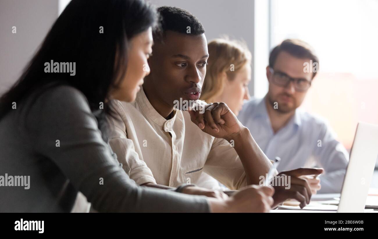 Multiracial coworkers brainstorm discuss business ideas at meeting Stock Photo - Alamy