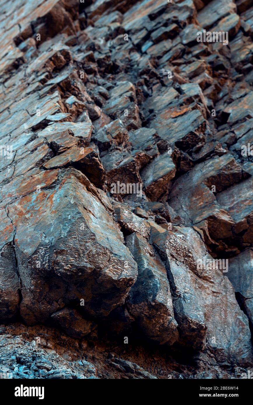 Natural basalt rock with cracks and crevices with a red color coming ...