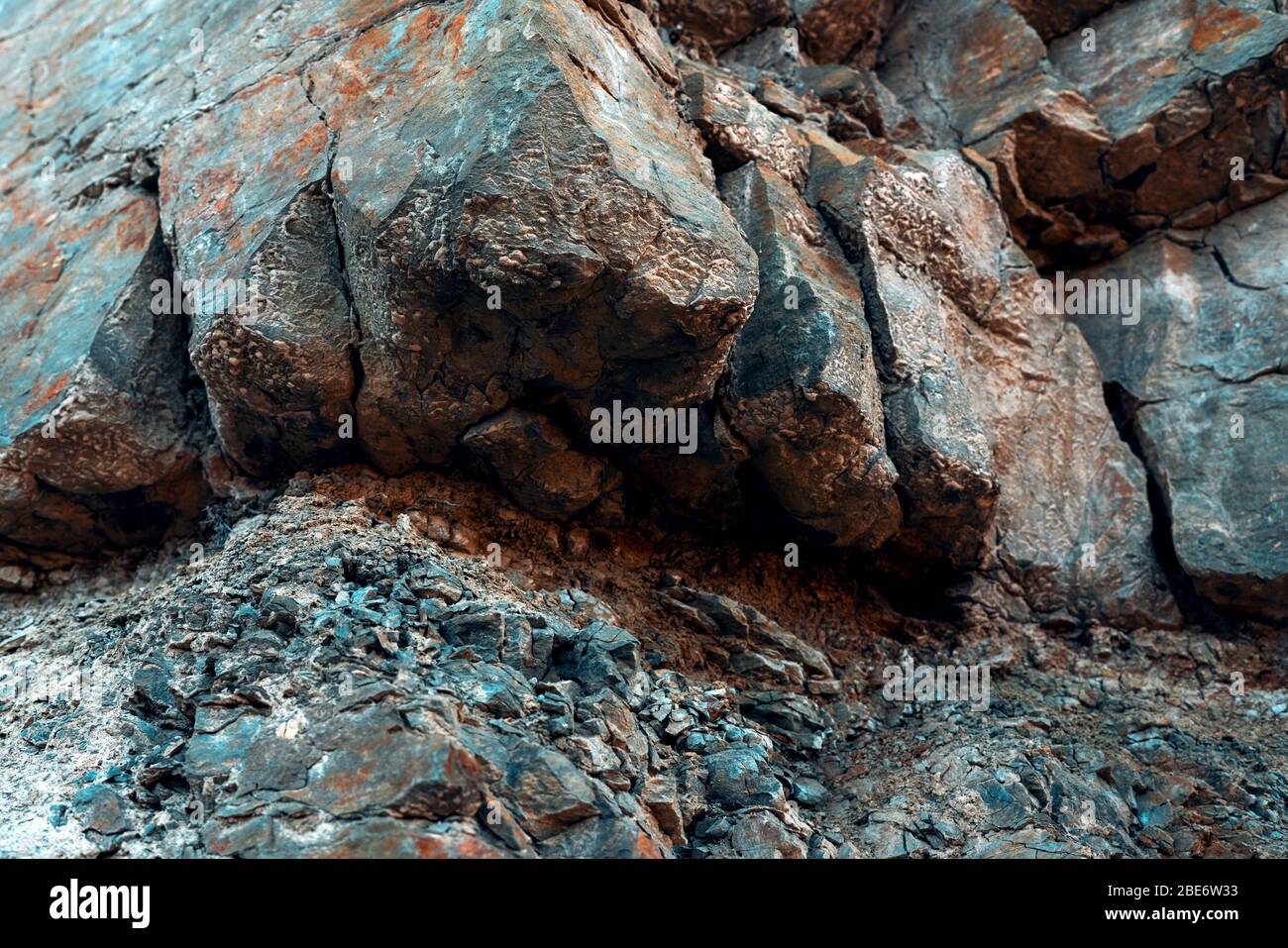Natural basalt rock with cracks and crevices with a red color coming ...