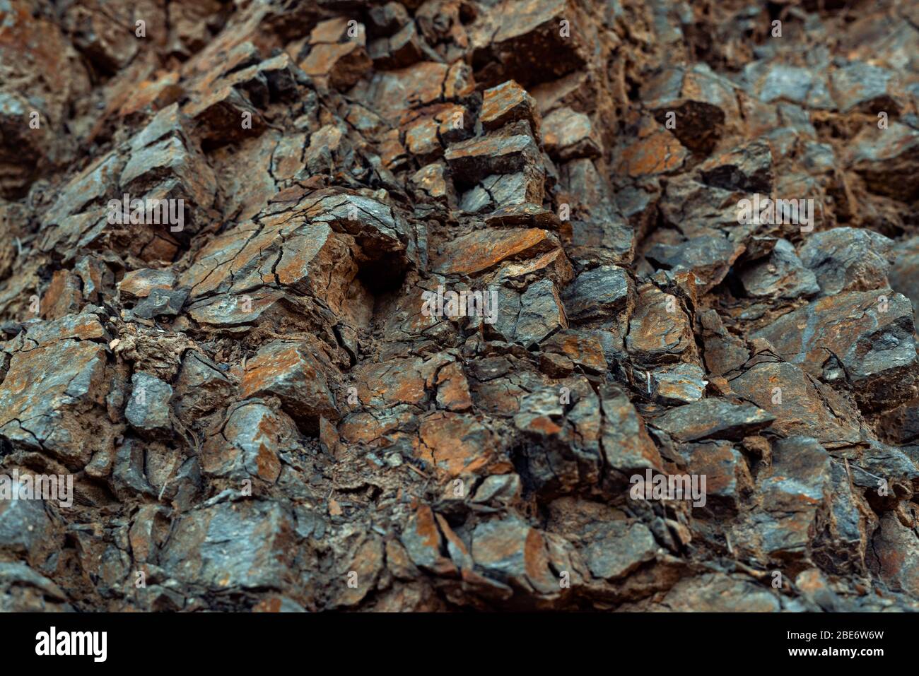 Natural basalt rock wall with cracks and crevices. Rock texture ...
