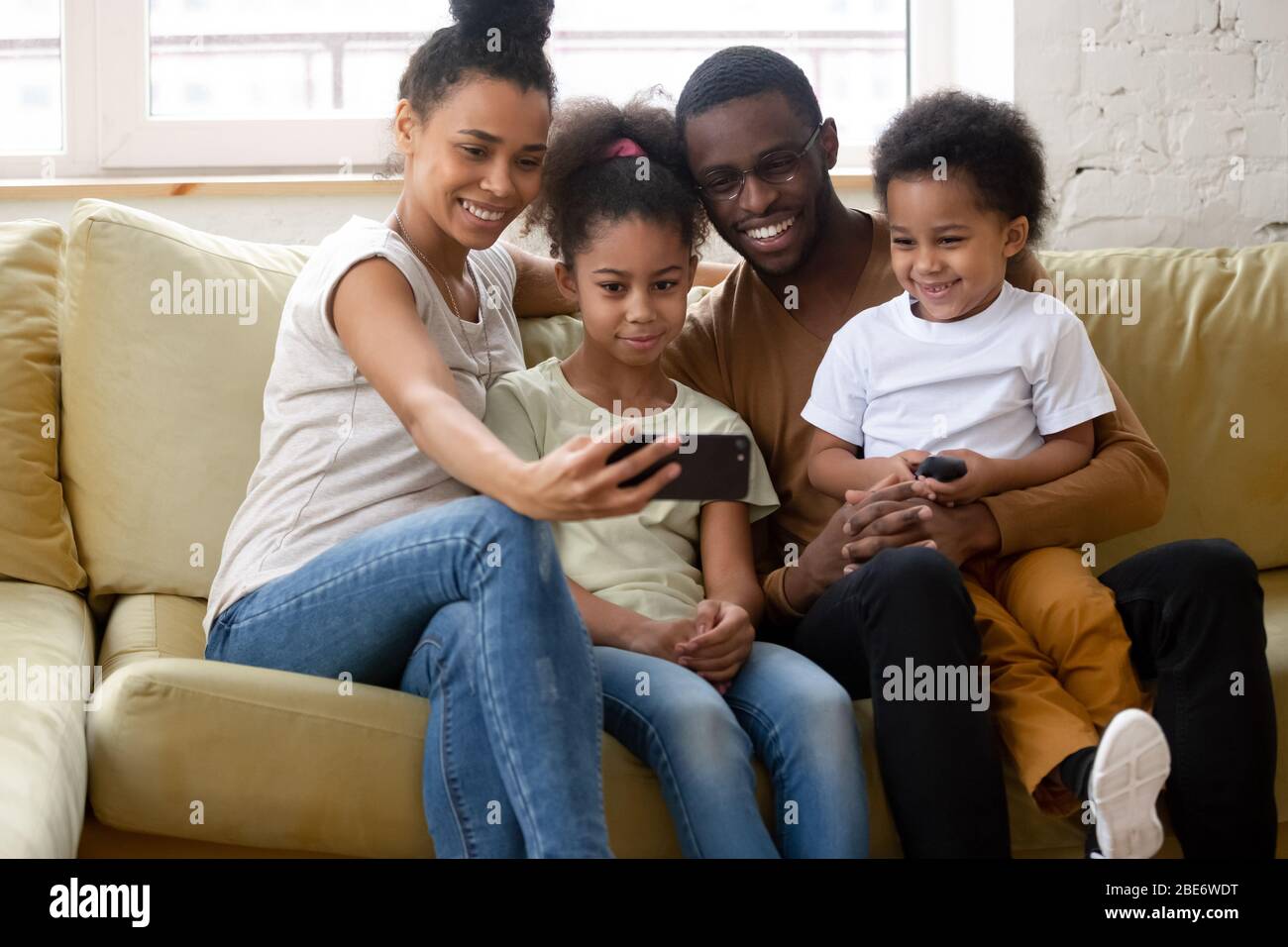 African American parent with two children taking selfie Stock Photo - Alamy