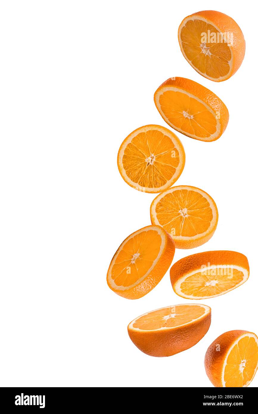 Flying fruits. Falling sliced orange fruit isolated on white background ...