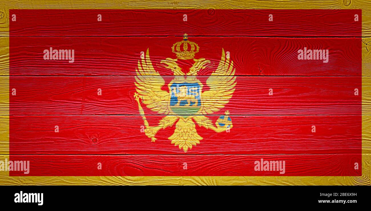 Montenegro flag painted on old wood plank background. Brushed natural ...